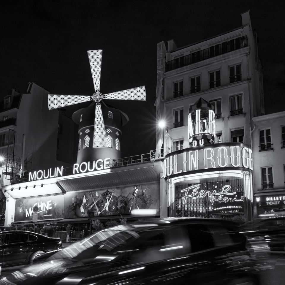 A late night shot of the iconic Moulin Rouge in Paris. - Swimstones