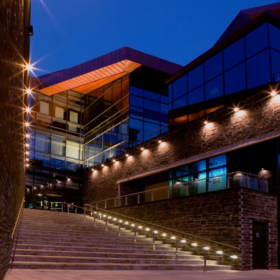 An evening image of The Roland Levinsky Building. - Swimstones